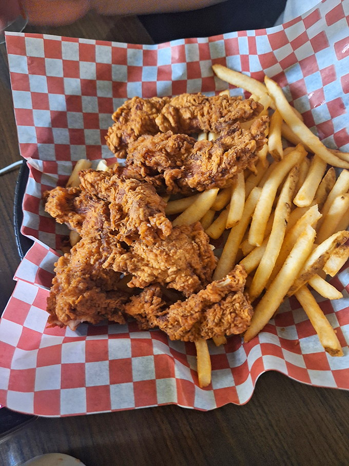 Crispy chicken tenders nestled on a bed of golden fries&mdash;the adult version of childhood joy that never lost its magic.
