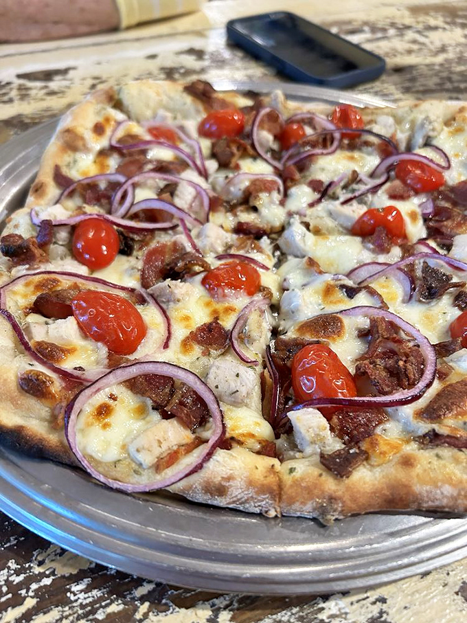 Red onions and cherry tomatoes add pops of color to this pizza canvas&mdash;proof that sometimes the simplest ingredients create the most memorable bites.
