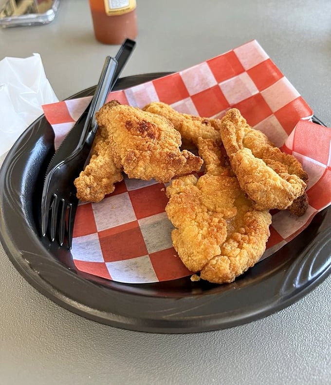 Even the chicken tenders here mean business &ndash; golden-fried to perfection on checkered paper, proving that seafood joints know their way around the fryer too.