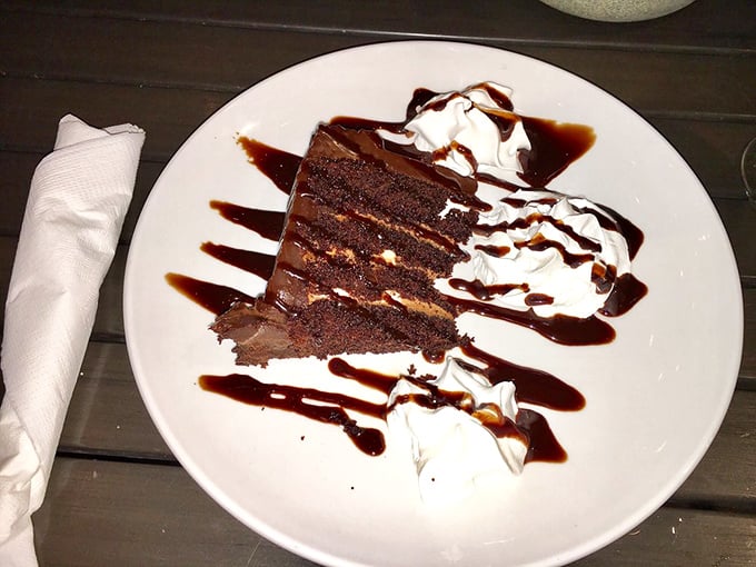 Death by chocolate? If so, what a way to go&mdash;layers of rich cake and frosting drizzled with sauce and topped with clouds of whipped cream.
