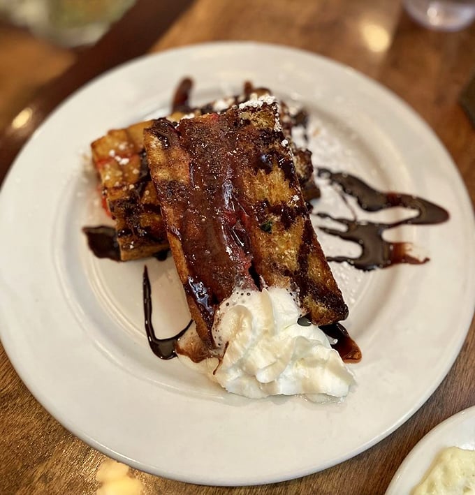 This chocolate-drizzled French toast isn't just dessert masquerading as breakfast – it's what your inner child would order if given free rein.