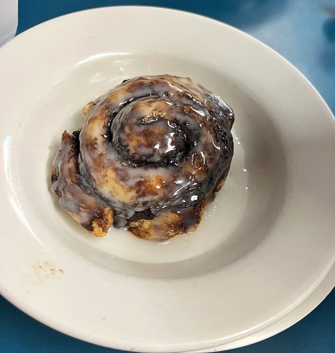 This cinnamon roll isn't playing games &ndash; it's the heavyweight champion of breakfast desserts, glazed with enough sweetness to fuel a morning at the track.