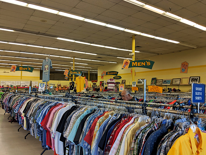 Color-coded clothing racks create a rainbow road of fashion possibilities spanning decades of style evolutions and revolutions.