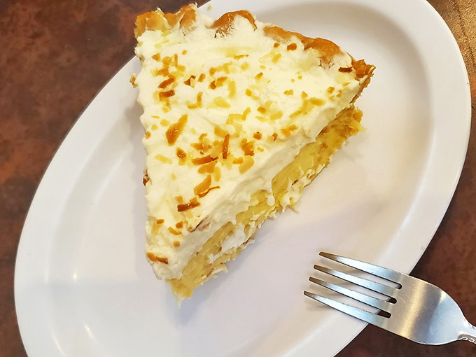 Coconut cream pie with a golden toasted top &ndash; the kind that makes you consider ordering dessert at 9 AM because life is short and pie is forever.