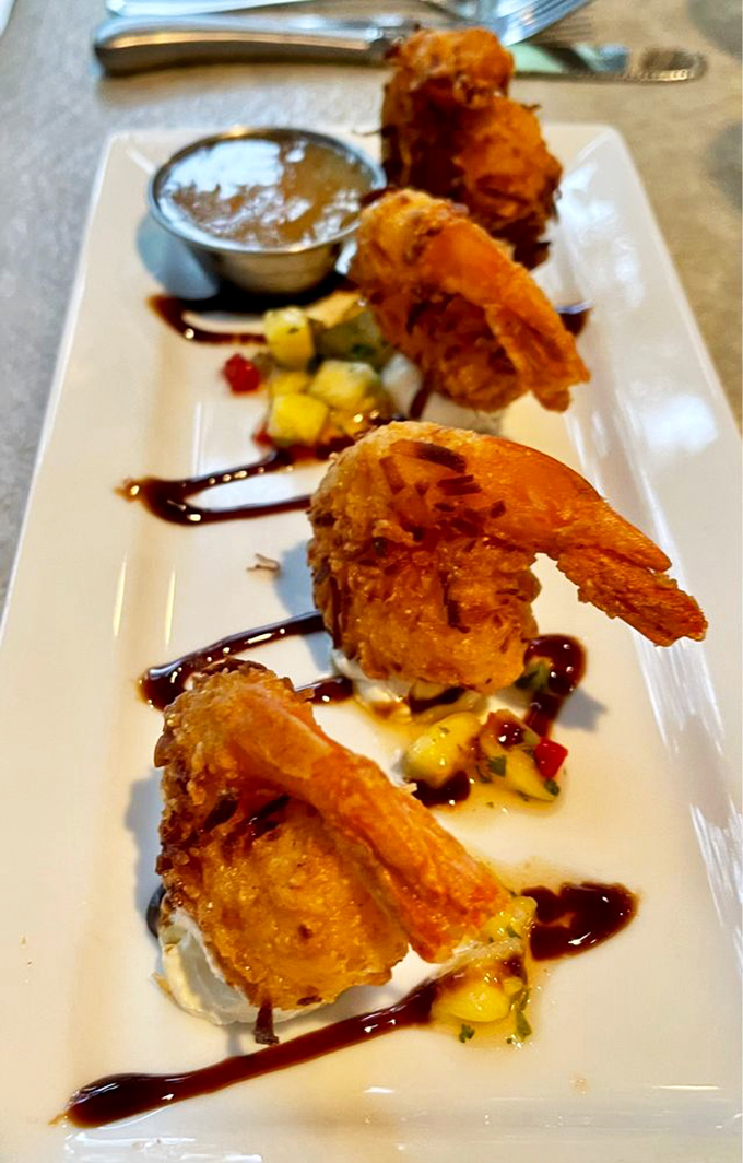 Coconut shrimp lined up like tropical soldiers, ready to march into flavor battle with sweet fruit salsa as their secret weapon.