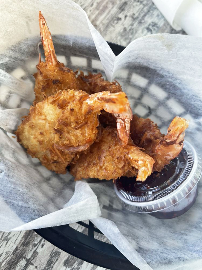 Coconut shrimp with tails intact, looking like they're ready to dive back into the ocean for more.