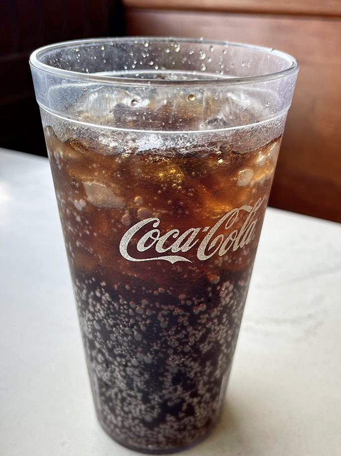 Ice-cold Coca-Cola in a proper glass because some partnerships were meant to last forever.