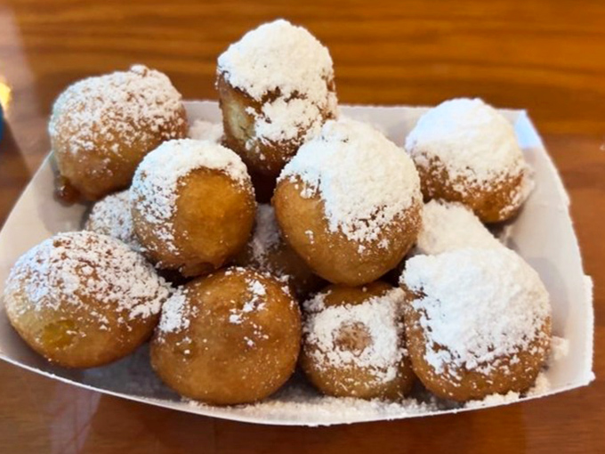 Powdered sugar-dusted corn fritters that blur the line between appetizer and dessert&mdash;a sweet prelude to seafood paradise.