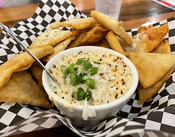 Crab dip surrounded by crispy triangles &ndash; like a delicious game of edible Trivial Pursuit where every answer is "more, please."