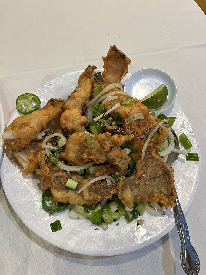 The crispy fried sole arrives like edible architecture&mdash;delicate fish transformed into a crunchy-tender masterpiece topped with a confetti of jalape&ntilde;os and scallions.