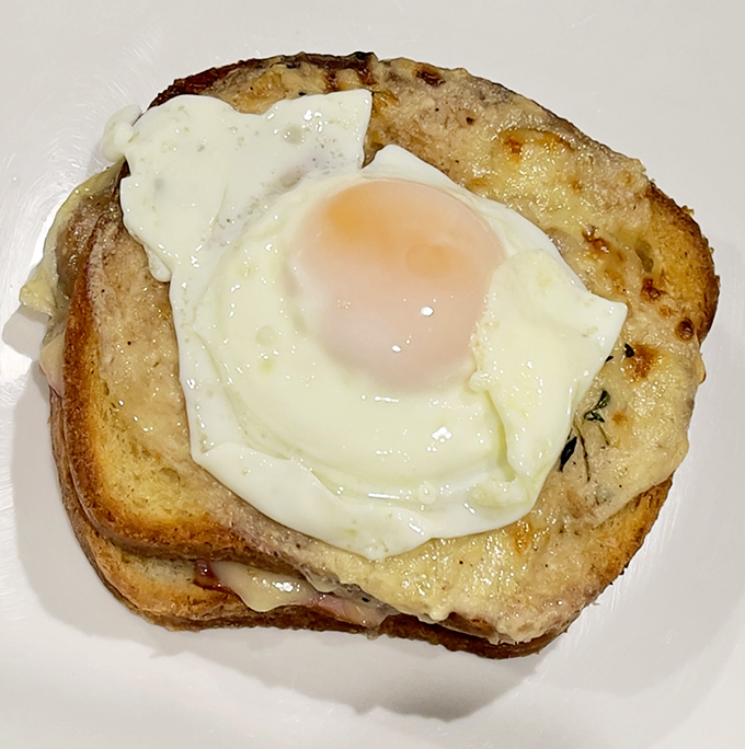 The elusive perfect egg &ndash; sunny side up with edges just crisp enough, perched atop what looks like a grilled cheese sandwich in a beautiful breakfast marriage.