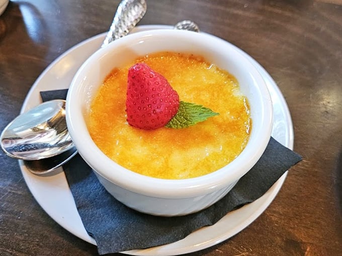 Cr&egrave;me br&ucirc;l&eacute;e with a perfectly torched top and fresh strawberry garnish&mdash;the dessert equivalent of a standing ovation.
