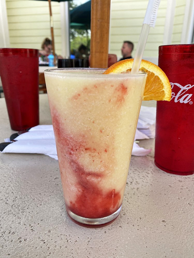 Tropical refreshment that looks as good as it tastes. This layered daiquiri with fresh orange garnish captures Florida in a glass.