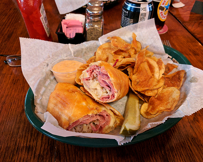 This sandwich and chips combo isn't just lunch&mdash;it's edible nostalgia served on a green plate. The pickle stands at attention like a tasty sentinel.