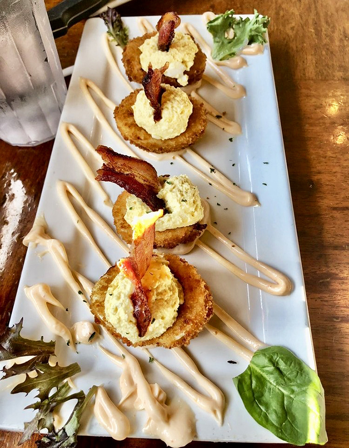 These aren't just deviled eggs—they're little works of art topped with bacon. The kind of appetizer that disappears before anyone admits taking seconds.