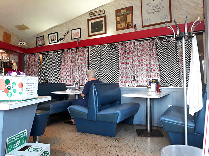 The dining area's blue booths have witnessed decades of conversations, confessions, and food-induced happiness.