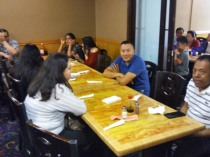Families gathered around tables, united in the universal language of "pass the butter sauce, please."