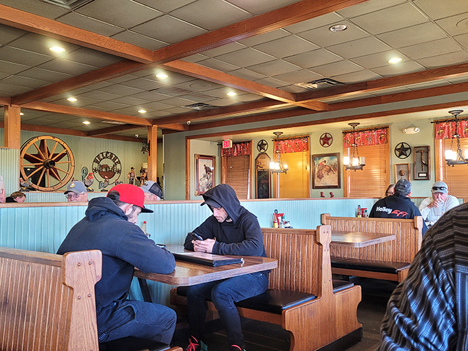 The morning crowd hunched over coffee cups, solving world problems one breakfast special at a time.