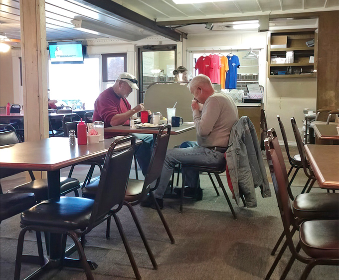 Two regulars sharing coffee and conversation &ndash; the real magic of diners happens between people, not just on plates.