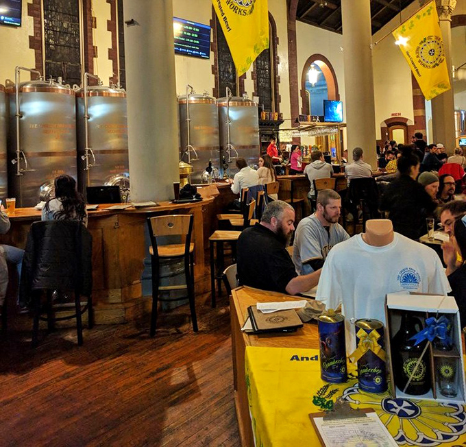 The congregation gathers for communion of a different sort, with steel brewing tanks standing sentinel like modern-day saints.