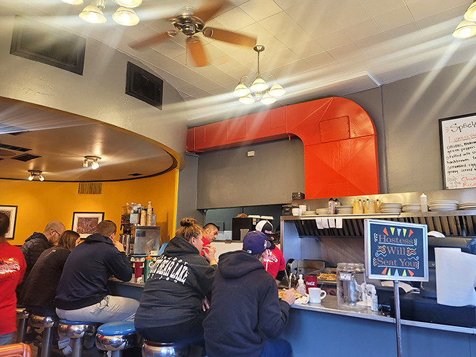 The counter seats&mdash;where breakfast philosophers gather to contemplate life's big questions while watching hashbrowns achieve crispy perfection.