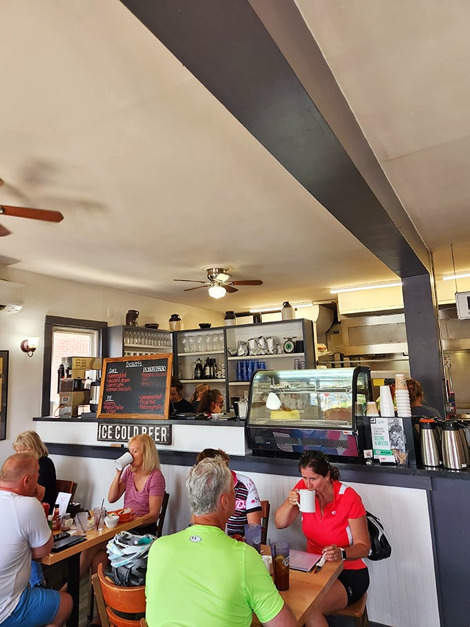 The bustling counter area captures diner culture in action—coffee cups raised like a caffeinated toast to the day ahead.