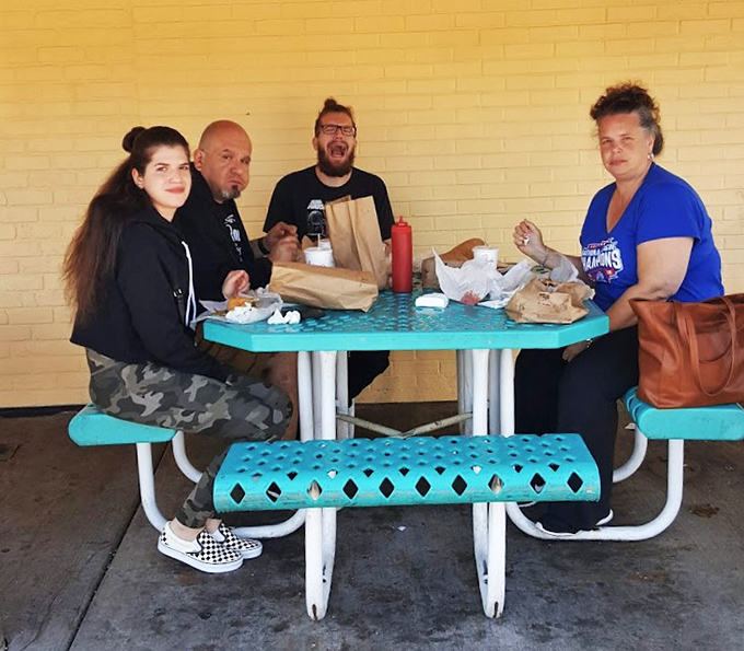 The outdoor picnic tables&mdash;where strangers become temporary family, united by the universal language of "this sandwich is worth the mess."