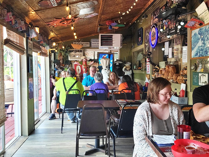 The dining area buzzes with conversation as patrons enjoy their meals surrounded by walls that tell a thousand fishing tales.