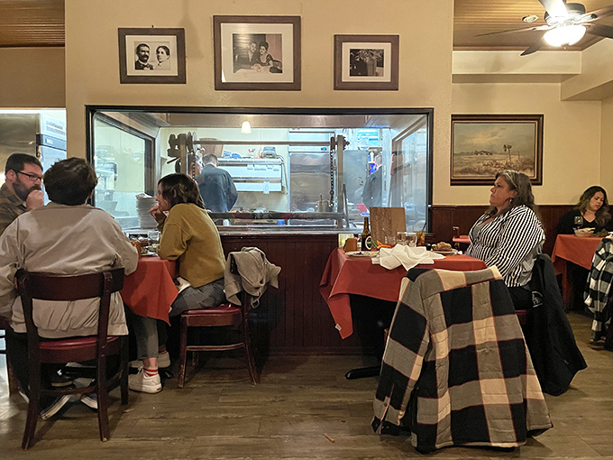The dining room buzzes with anticipation as guests watch the kitchen's choreography through the glass&mdash;dinner and a show in one.