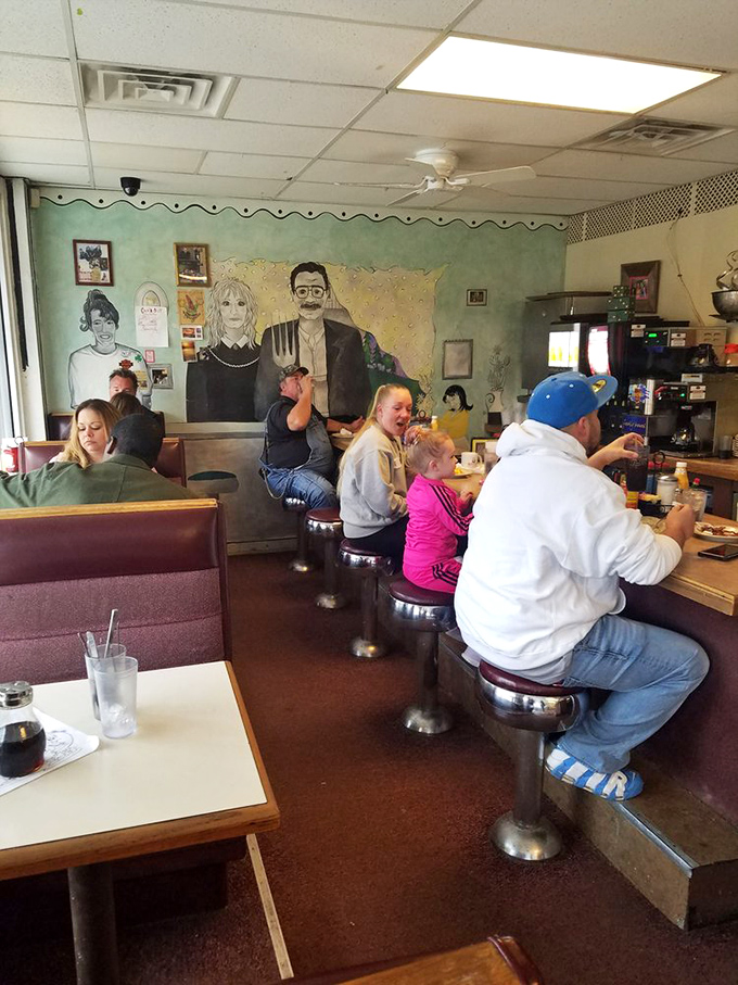 Where families gather at the counter, creating memories over pancakes while the iconic mural watches approvingly from behind.