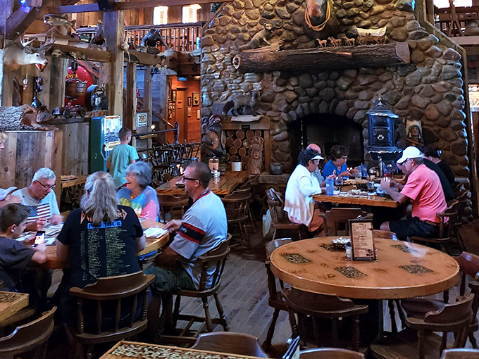 Diners gather beneath the impressive stone fireplace, creating a Norman Rockwell painting come to life &ndash; if Norman had appreciated antler chandeliers.