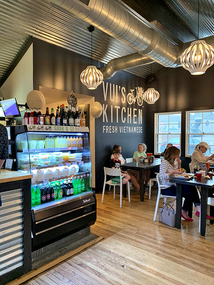 Where food brings people together: diners enjoying their Vietnamese feast beneath industrial-chic pendant lights and exposed ductwork.