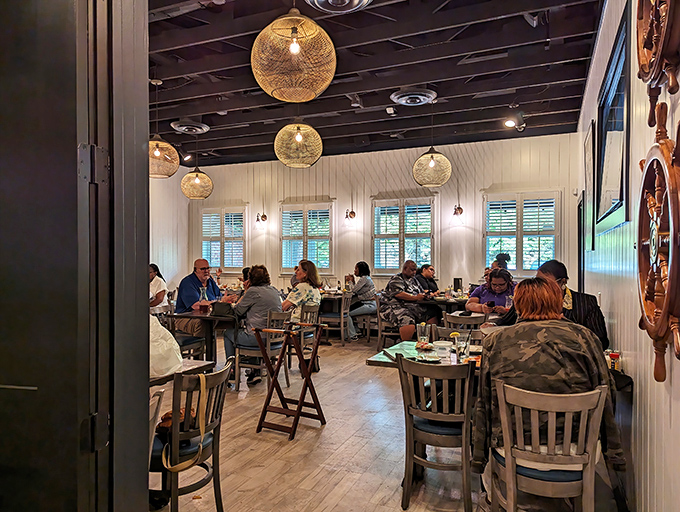 Light-filled dining room where conversations flow as easily as the seafood. Those pendant lights cast the perfect glow for admiring your Crab Bomb before it disappears.