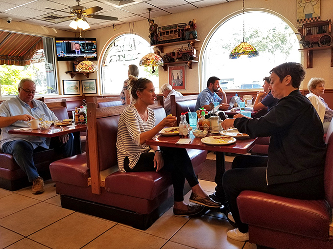 Locals and visitors alike fill these comfortable booths, creating that perfect diner energy where everyone seems just one coffee refill away from becoming friends.