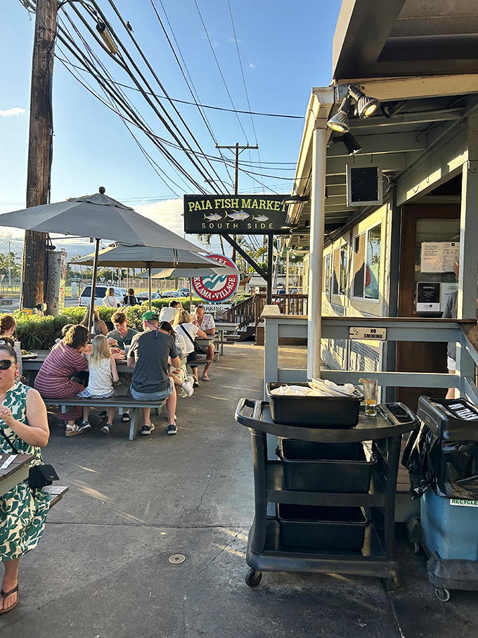 The outdoor seating area where strangers become friends over shared tales of island adventures and seafood conquests.