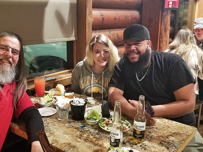 Happy diners enjoying a feast fit for a cowboy king. Smiles wider than the Montana sky &ndash; that's the true Land of Magic effect. 