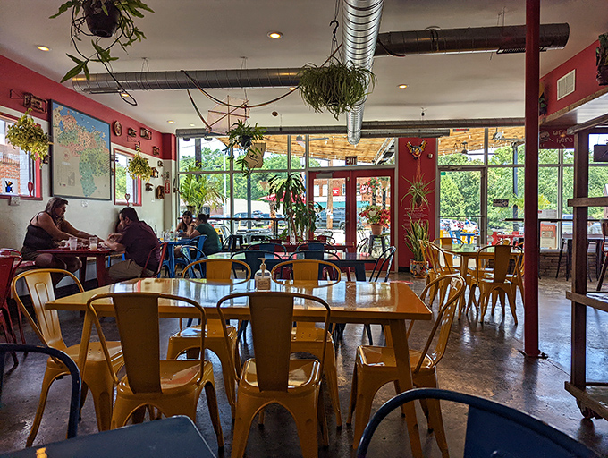 Sunlight streams through floor-to-ceiling windows, illuminating a space where serious eating happens. Those yellow chairs practically radiate happiness.