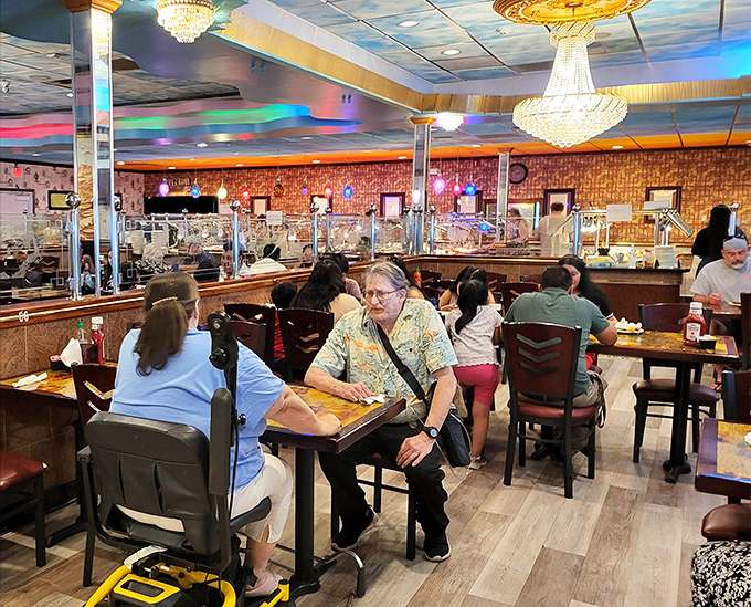 Where food meets fellowship—diners of all ages gather under crystal chandeliers, proving that good value and good times know no demographic boundaries.