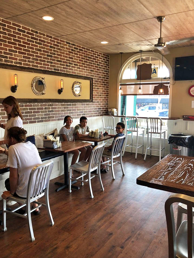 Families gather around wooden tables beneath exposed brick walls. Some conversations pause mid-sentence when the food arrives&mdash;the highest compliment.