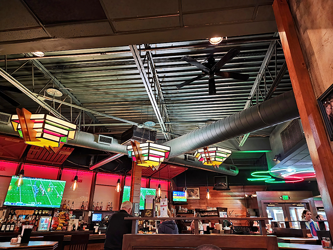 The exposed ductwork and colorful lighting create that perfect "fancy enough for date night, casual enough for Tuesday" vibe.