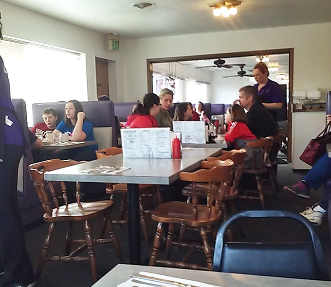 Families gathering around laminated menus&mdash;the modern tribal council where the important decision of "pancakes or waffles?" is debated with proper gravity.