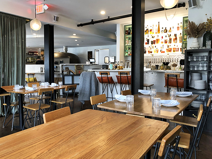 Another angle reveals more happy diners and that bar beckoning like a siren of sophisticated spirits.