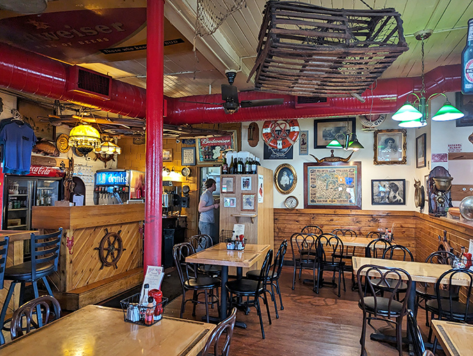 The dining room feels like the galley of the world's most welcoming ship. Those red pipes aren't just functional—they're part of the charm.