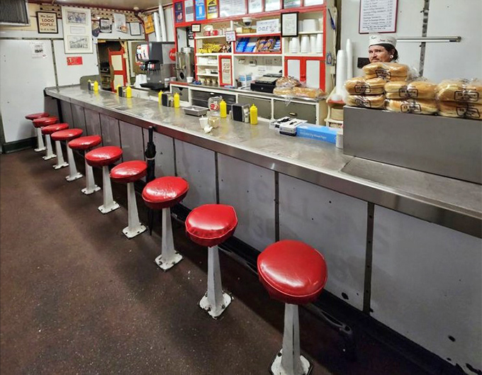 The counter stretches like a runway for culinary delights, each red stool a front-row seat to one of Virginia's greatest food shows.