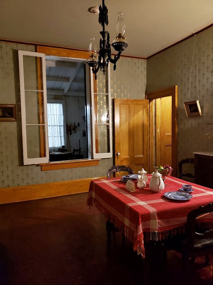 Set the table for dinner in this Victorian dining room, complete with period chandelier and vintage tablecloth.