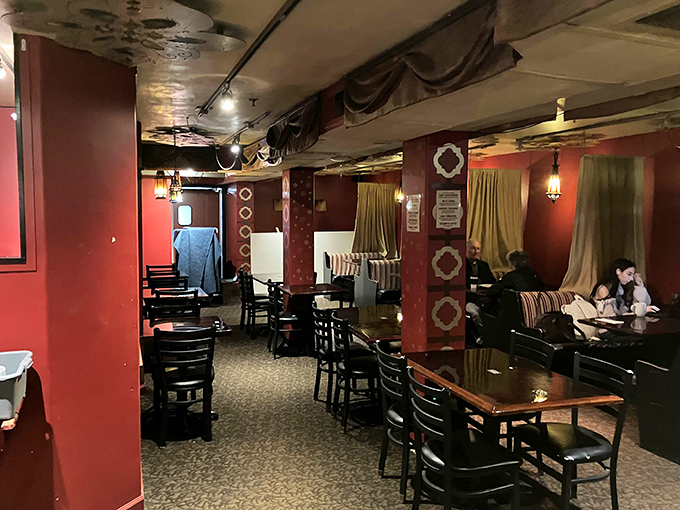 Red walls that somehow make everyone look like they're having the best day ever. The theater entrance beckons with promises of entertainment.