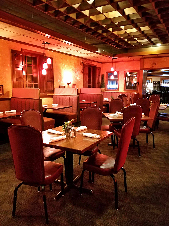 Red chairs and warm lighting create that classic Italian restaurant atmosphere where memories are made between bites of pasta.
