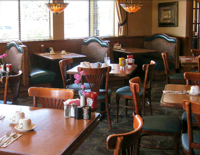 Cozy booths and warm wood tones create breakfast sanctuaries where morning conversations bloom over steaming plates.