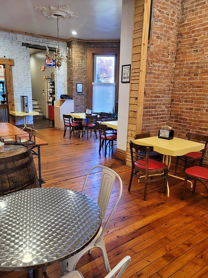 Yellow tables pop against rustic brick walls, creating dining spaces that feel both intimate and communal &ndash; the barbecue equivalent of a warm hug.