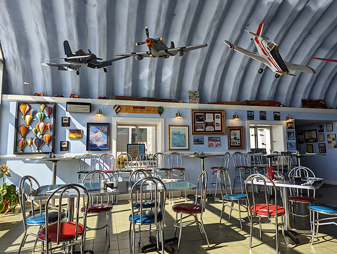 Every seat offers a view of aviation history. The colorful chairs add playful pops against the hangar's industrial backdrop&mdash;diner aesthetics with wings.